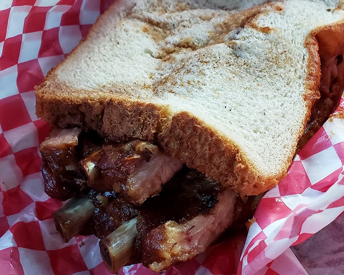 The rib sandwich—where bread serves merely as a delivery system for smoky, tender meat that's the star of the show.