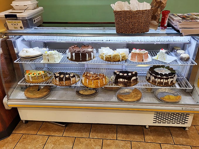 The dessert case—where willpower goes to die. Each cake and pie making silent promises that "calories consumed in diners don't count."