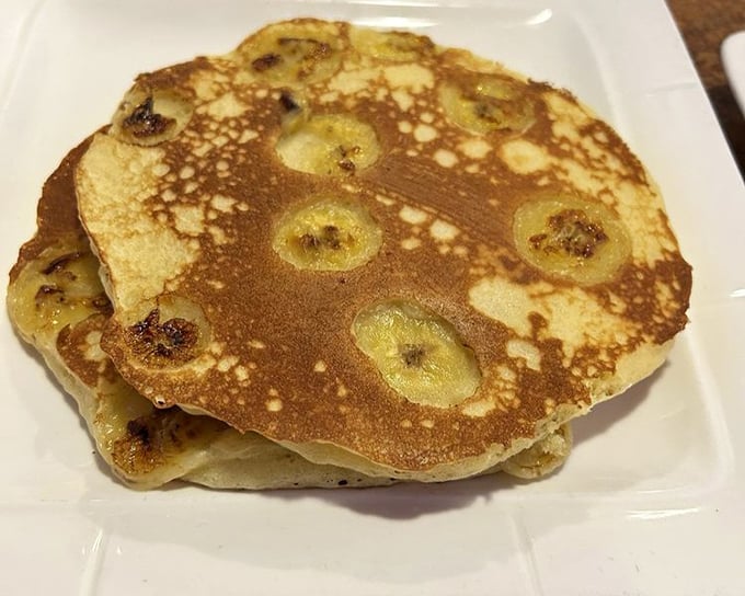 Banana pancakes with caramelized fruit baked right in—proof that someone in the kitchen understands that breakfast should never be boring.