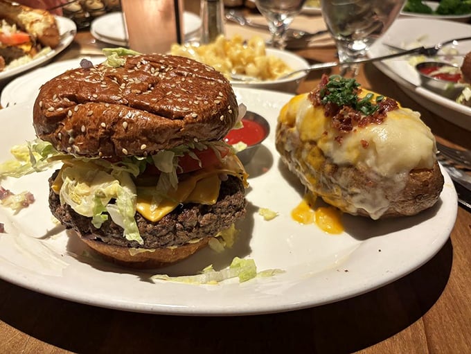 A burger that requires jaw exercises beforehand, paired with a twice-baked potato that's living its best, most cheese-covered life.