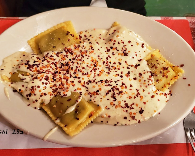 Pillowy ravioli swimming in creamy sauce with red pepper flakes—proof that pasta and cheese are humanity's greatest collaboration.