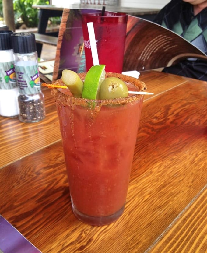 A Bloody Mary garnished like it's trying to upstage the main course. That rim isn't just spiced—it's an adventure waiting to happen. 