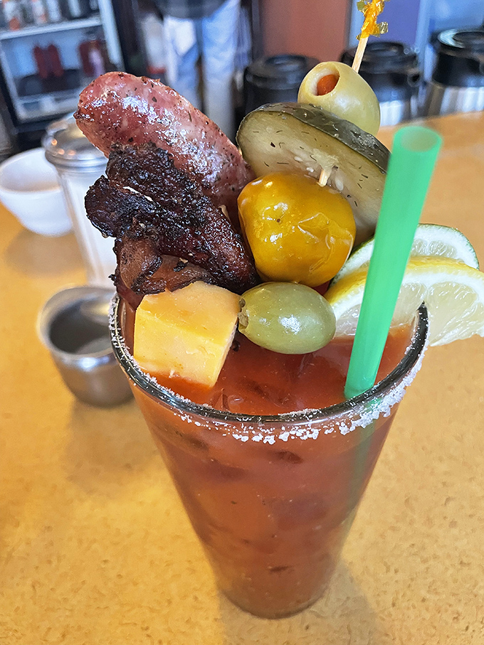 This Bloody Mary isn't just a drink—it's an entire appetizer course. That bacon strip isn't garnish—it's the exclamation point on a liquid brunch.