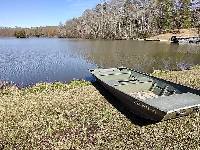 A humble fishing boat waits patiently by Lake Crawford's shore – no fancy yacht required for the simple pleasure of drifting among rippling reflections.
