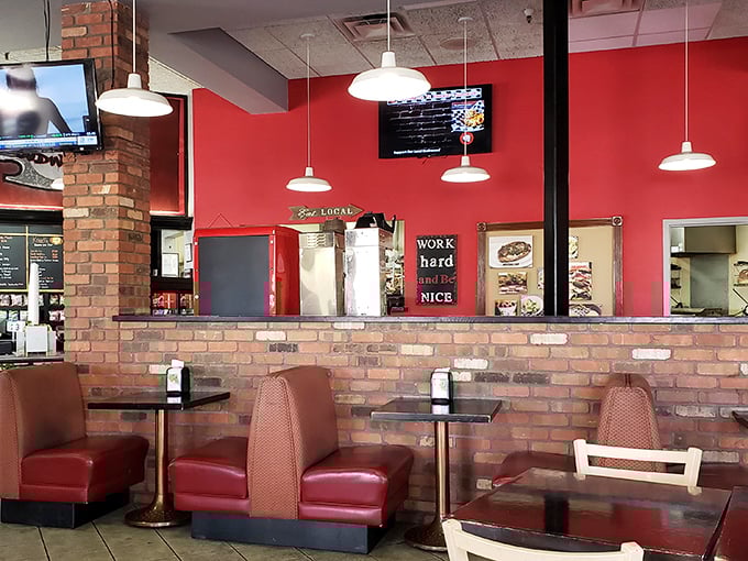 Those red booths aren't just seating—they're front-row tickets to the comfort food show. The brick wall adds that perfect touch of no-nonsense charm.