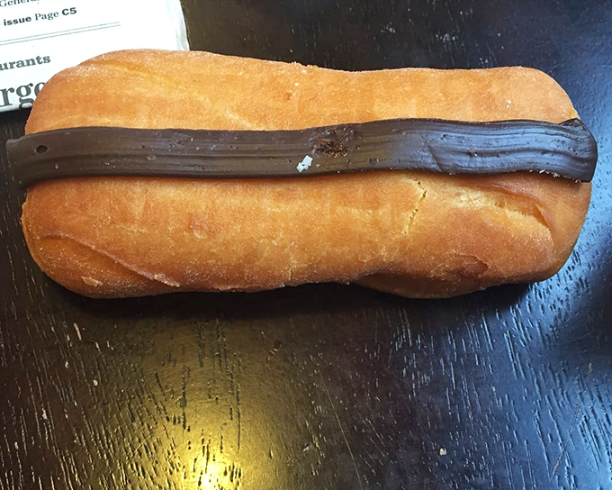 The chocolate-topped eclair—proof that sometimes the simplest combination of pastry, chocolate, and cream can still stop conversation mid-sentence.