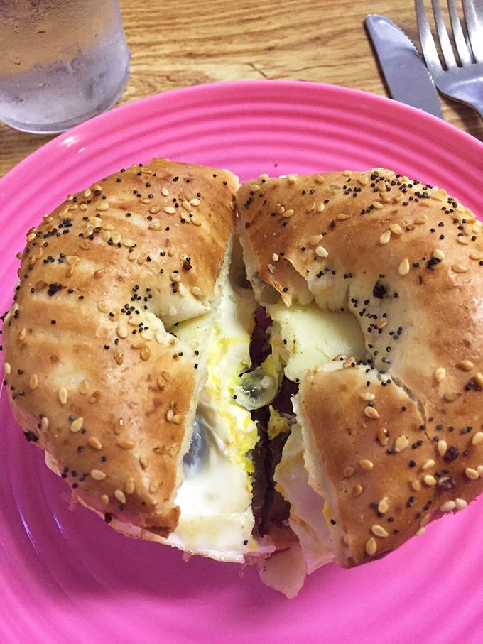 Bagel sandwich perfection! That golden-seeded beauty with its melty center is the breakfast handshake we all deserve to start our day.