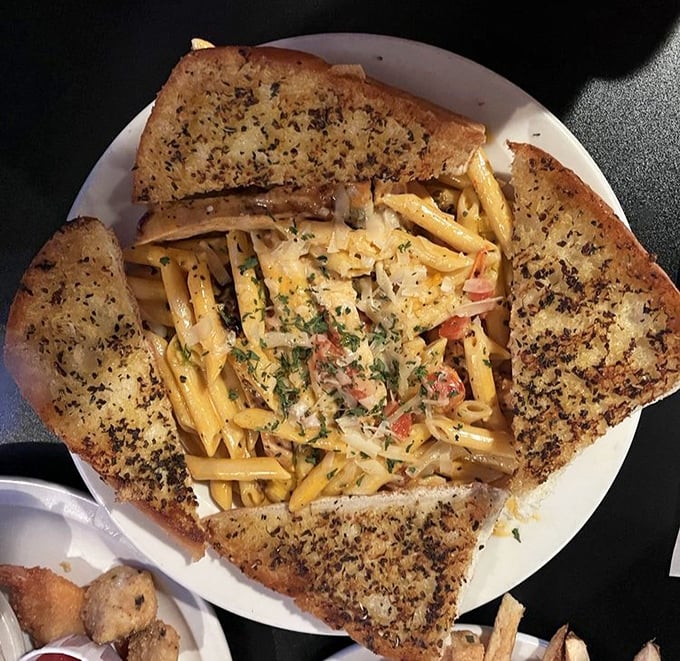 Pasta that doesn't just sit on the plate but tells a story – each piece of garlic bread ready to soak up sauce too good to leave behind.