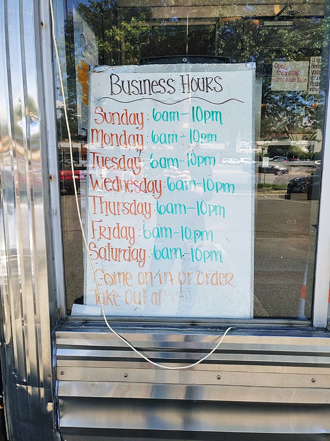 Business hours that respect the fundamental human right to pancakes at any hour. The handwritten sign adds that perfect touch of diner authenticity.