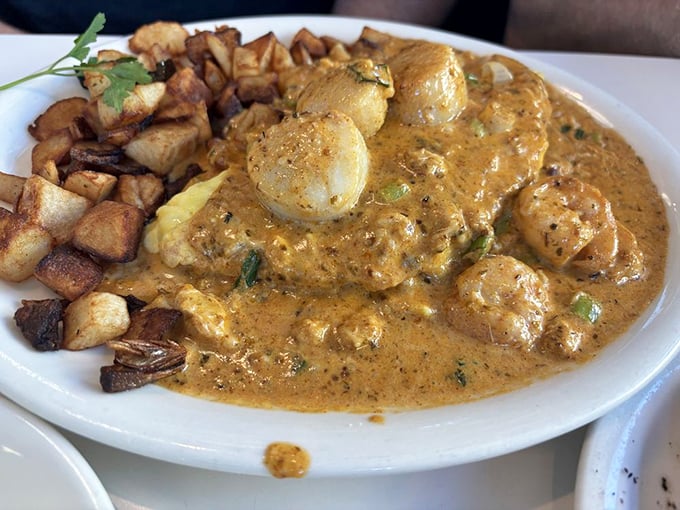 The Cajun seafood omelet with home fries—where breakfast meets New Orleans in a flavor collaboration that deserves its own jazz soundtrack.