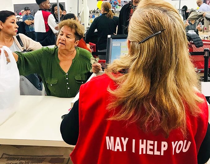 "May I Help You" isn't just on the back of her vest—it's the philosophy that makes this place more than just a store.