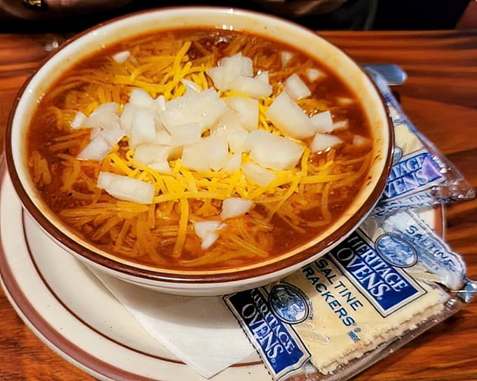This isn't just chili—it's a warm hug in a bowl, topped with enough cheese and onions to make you temporarily forget your troubles.