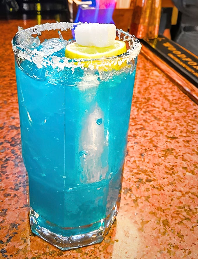 Electric blue and dangerously refreshing. This cocktail isn't just a drink—it's vacation in a glass, even if you're just in Lakeland.
