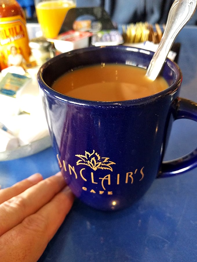 The signature blue mug—where coffee isn't just served, but presented as the liquid courage needed to face whatever Tuesday has planned for you.