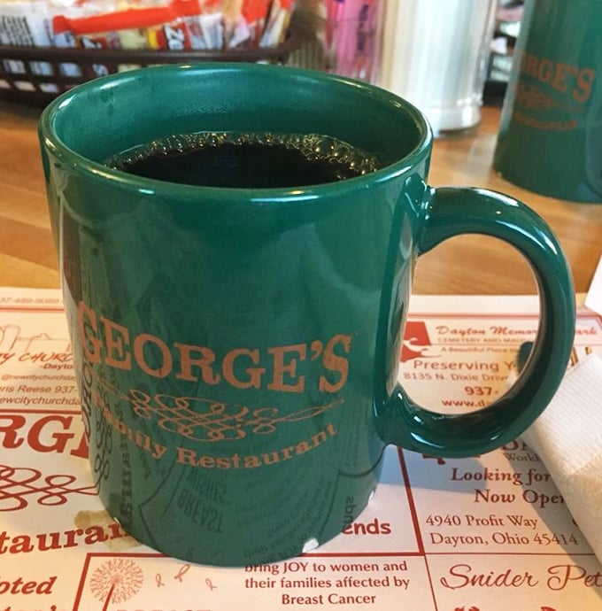 That signature green mug doesn't just hold coffee – it holds the fuel that powers half of Dayton through their morning meetings.