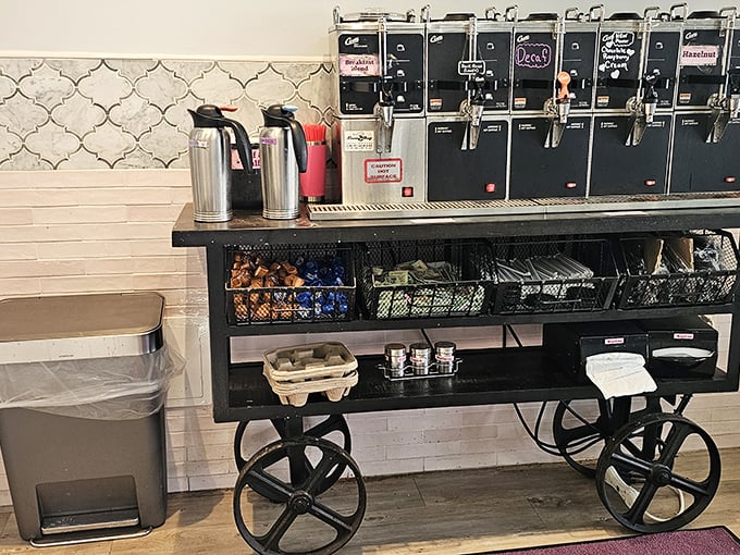 The coffee station, where industrial-chic meets caffeine necessity—because something has to wash down all those pastries.