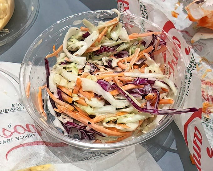 Crisp, colorful coleslaw that brings the crunch factor – the perfect cool counterpoint to the warm embrace of a hot cheesesteak.