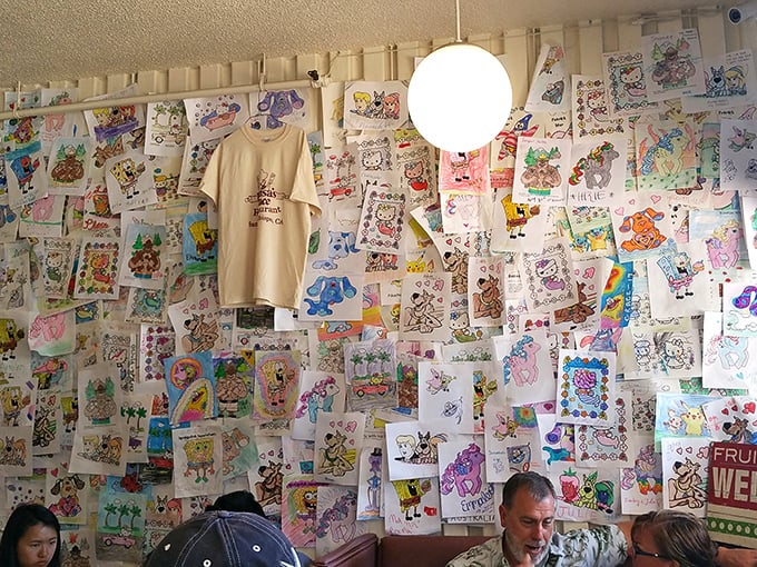 The wall of children's drawings isn't just decoration—it's a community art gallery where crayons and imagination create the most honest restaurant reviews.