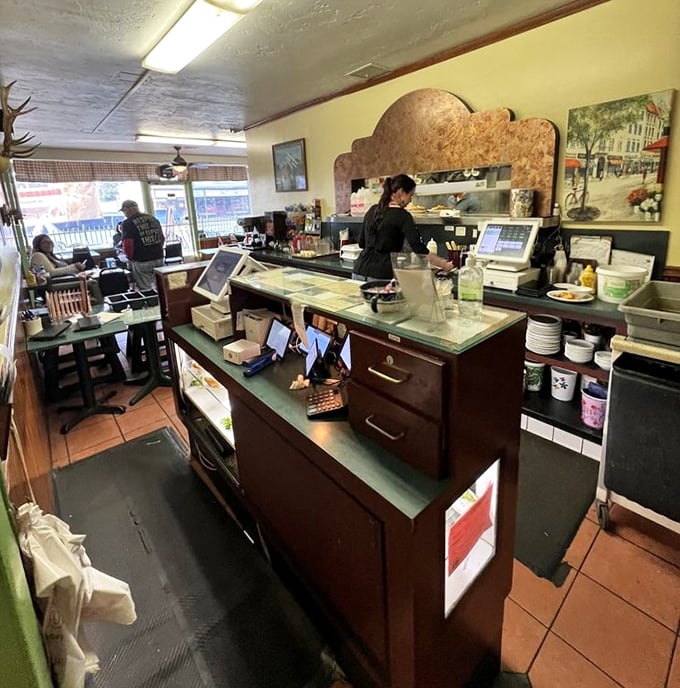 Where the magic happens—the counter where orders are called and plates emerge bearing comfort food that defies modern diet trends.