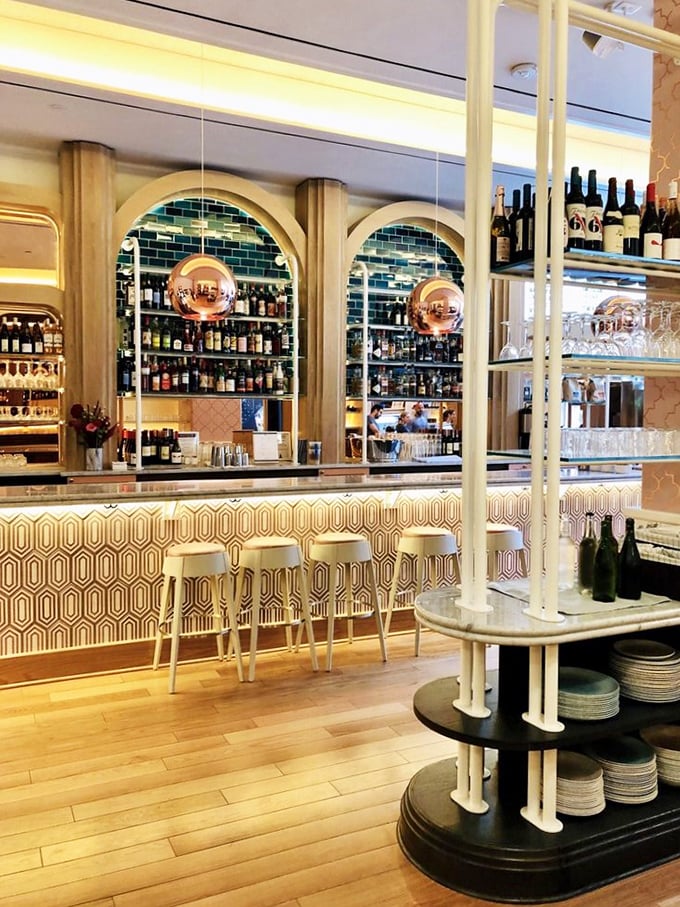 The bar area's warm wood tones and geometric patterns create a space that feels both retro and thoroughly modern—like stepping into a design magazine that serves amazing food.