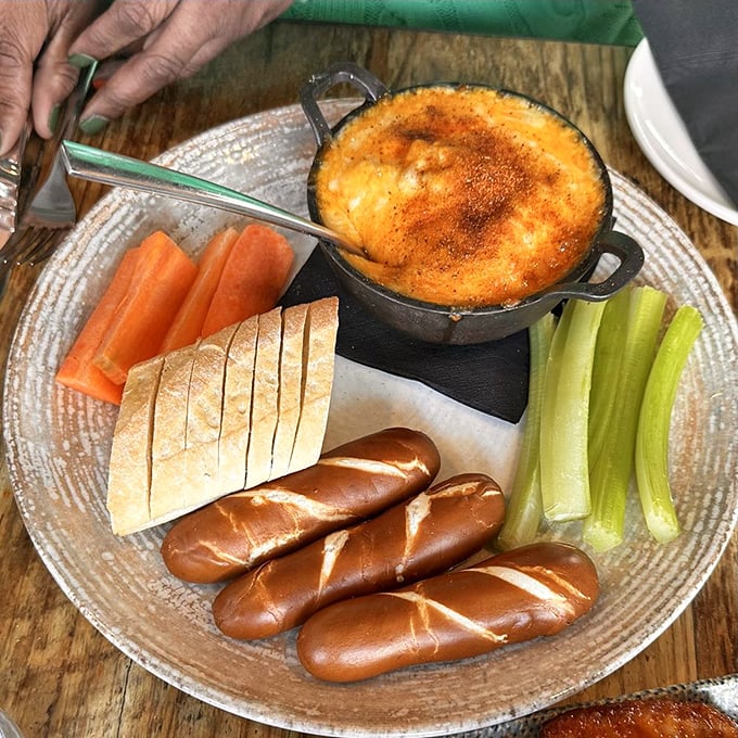 This isn't just crab dip—it's Maryland's soul in a cast-iron skillet. The pretzel bread and fresh vegetables are perfect vehicles for this molten masterpiece.