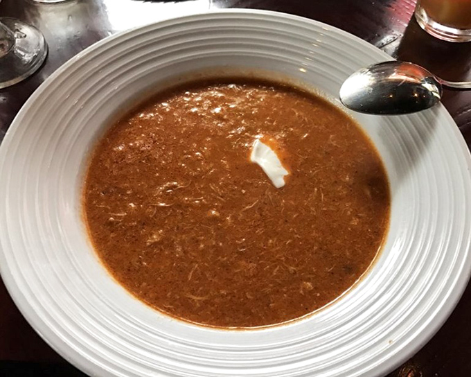 This velvety crab bisque with its rich, creamy texture delivers oceanic bliss in every soul-warming spoonful.