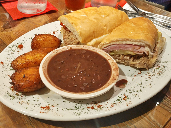 The Cuban sandwich—ham, roast pork, Swiss, pickles, and mustard pressed between bread—is diplomacy on a plate. Those plantains are the perfect ambassadors.