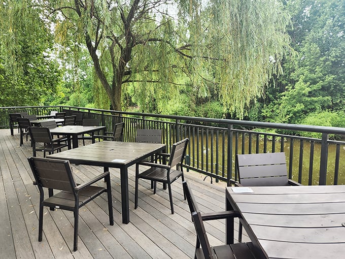The outdoor deck offers breakfast with a side of nature—where weeping willows and fresh air enhance flavors better than any seasoning could.