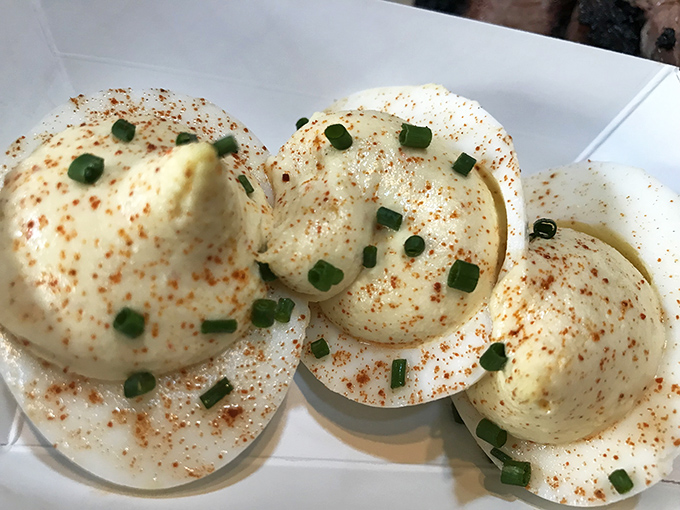 Deviled eggs that have clearly made a deal with the devil—impossibly creamy, perfectly spiced, and guaranteed to disappear faster than you can say "pass the plate."