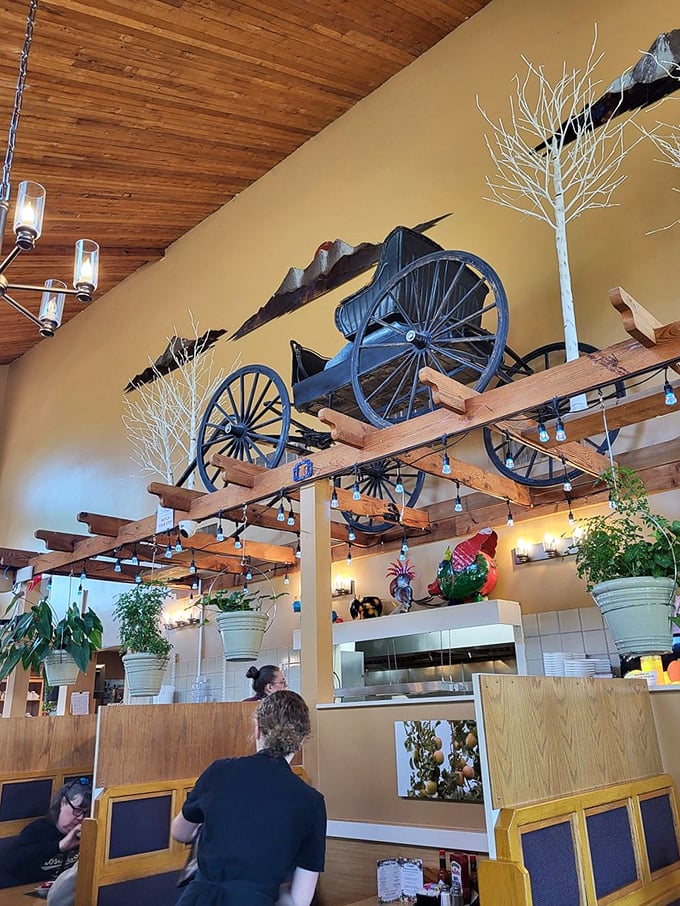 Look up to spot the antique wagon wheel suspended from wooden beams—rustic charm that pairs perfectly with homestyle cooking.