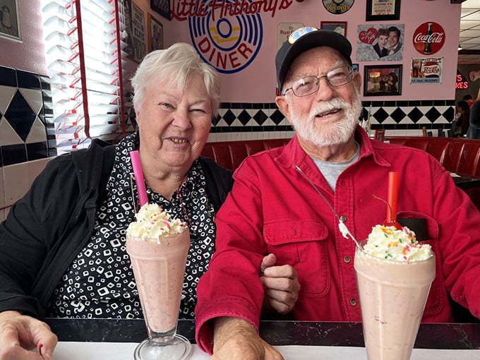 These aren't just customers enjoying milkshakes—they're living proof that some pleasures never go out of style, especially when topped with whipped cream and a cherry.
