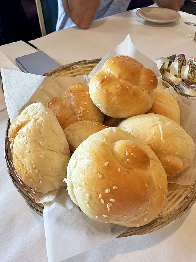 These sesame-topped dinner rolls aren't just bread – they're edible sponges designed specifically for soaking up every last drop of that magnificent sauce.