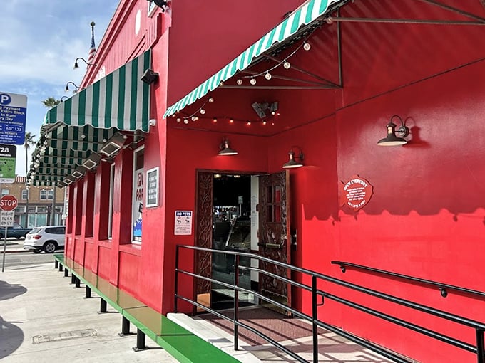 That vibrant red exterior with green-striped awnings isn't just a building – it's a landmark that's guided hungry Newport Beach visitors to seafood happiness for generations.