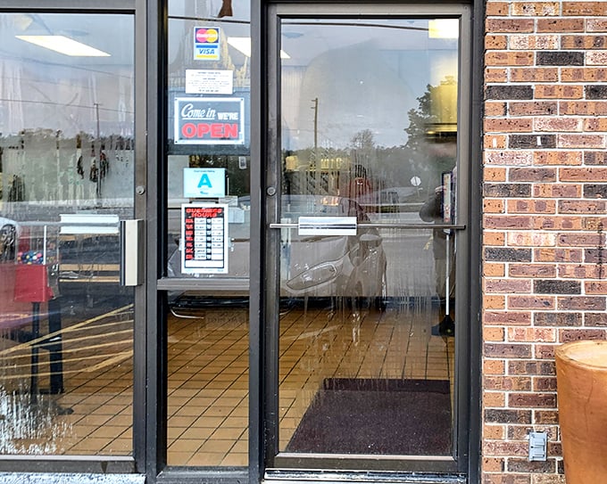 The entrance promises no frills, just honest food—a glass door that might as well be a portal to a simpler time when meals weren't photographed, just thoroughly enjoyed.
