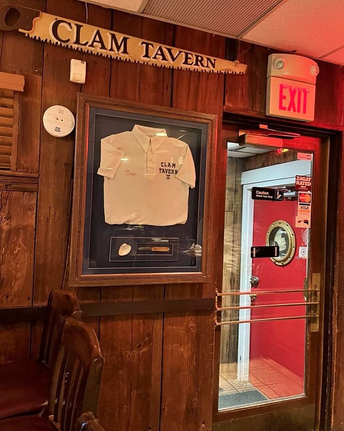 A framed Clam Tavern shirt and that signature red door—small touches that speak to decades of seafood tradition and local pride.