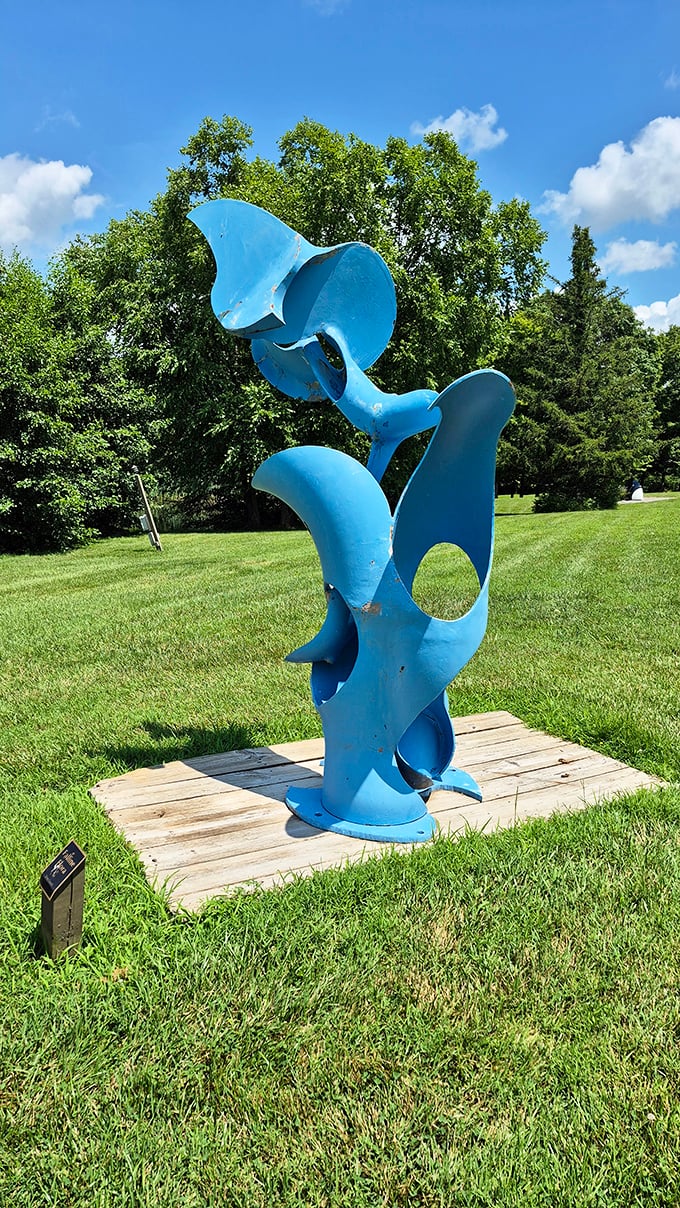 This blue sculpture twists skyward like frozen jazz, its curves and openings creating a different composition from every angle you approach.