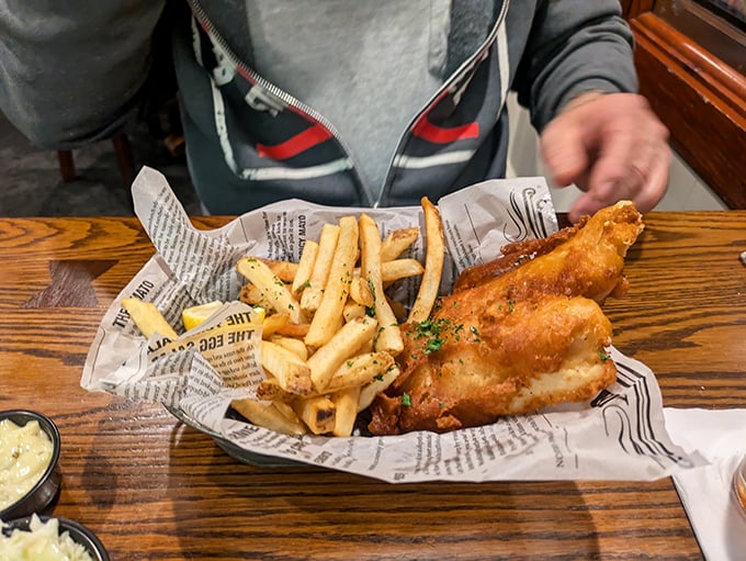 Fish and chips served on newspaper—old-school done right. That golden batter is the superhero cape this fresh fish deserves. 