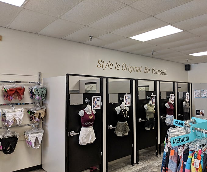 "Style Is Original. Be Yourself" proclaims the wall, while the fitting rooms stand ready for fashion truth-telling without the department store lighting horror.