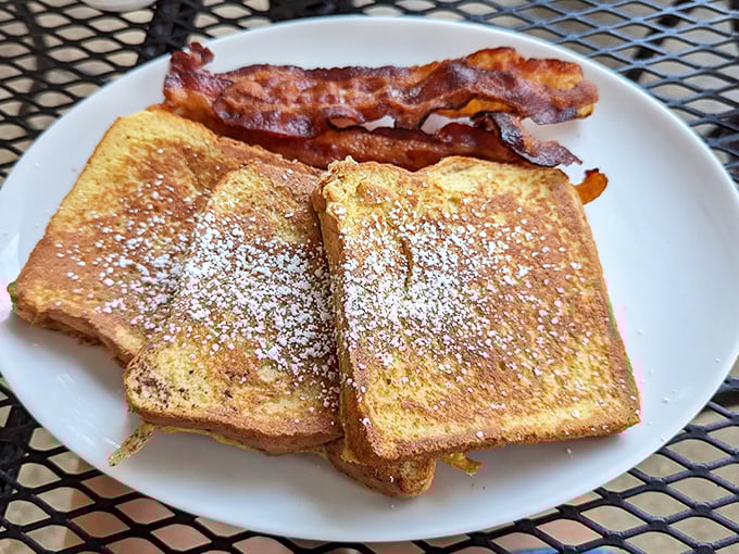 French toast dusted with powdered sugar and paired with bacon – breakfast's perfect sweet-and-savory romance story on a plate.