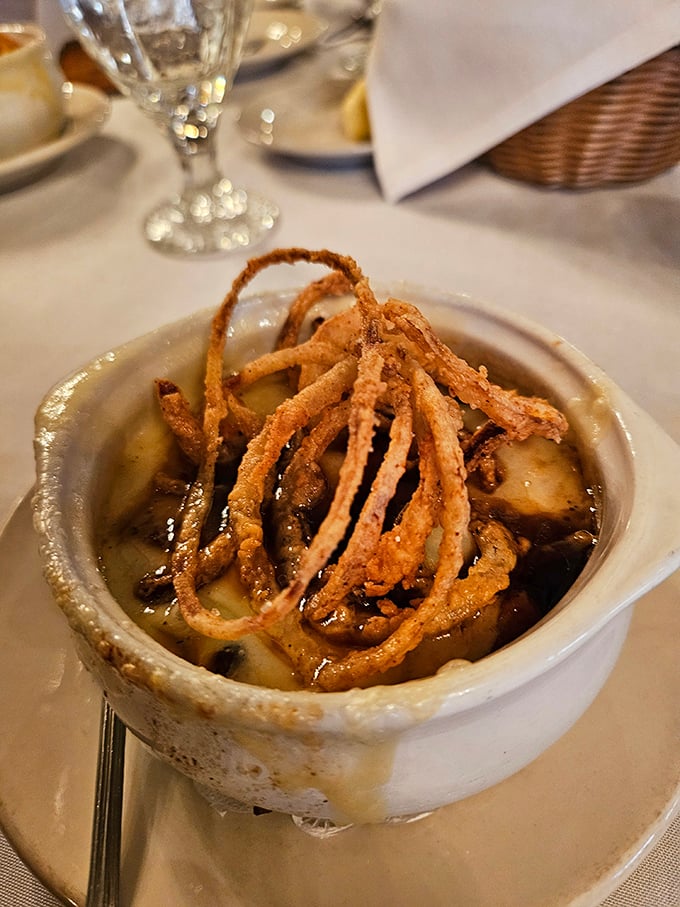 French onion soup with a crown of crispy onions—because sometimes cheese needs to wear a crunchy hat to the party.
