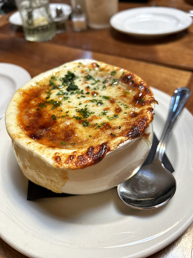 French onion soup with a golden crown of bubbling cheese that stretches dramatically with each spoonful. It's comfort in a crock.