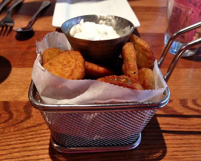 Fried pickles arrive hot, crispy, and ready for their cool dip in creamy sauce – the perfect opening act before the burger main event.