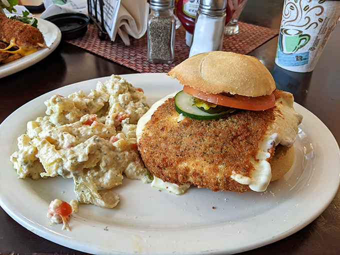 A fried cheese sandwich that makes grilled cheese hang its head in shame—crispy, gooey, and served with a side of potato salad perfection.