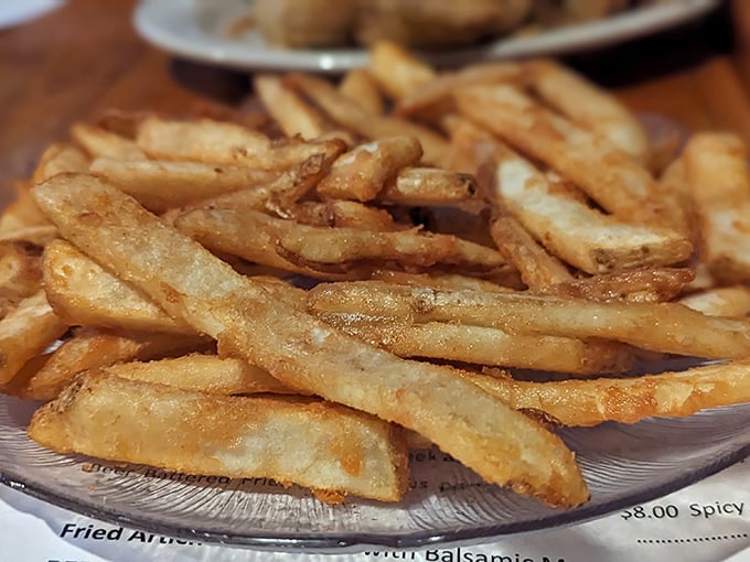 These aren't just fries – they're golden wands of potato perfection that somehow maintain their crispness from first bite to last.