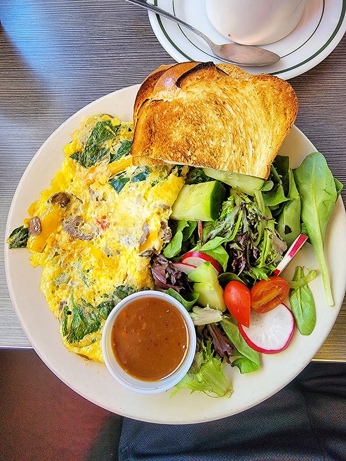 An omelet that's clearly been to the farmers market, bringing back souvenirs of fresh vegetables, served with toast that's achieved golden perfection.