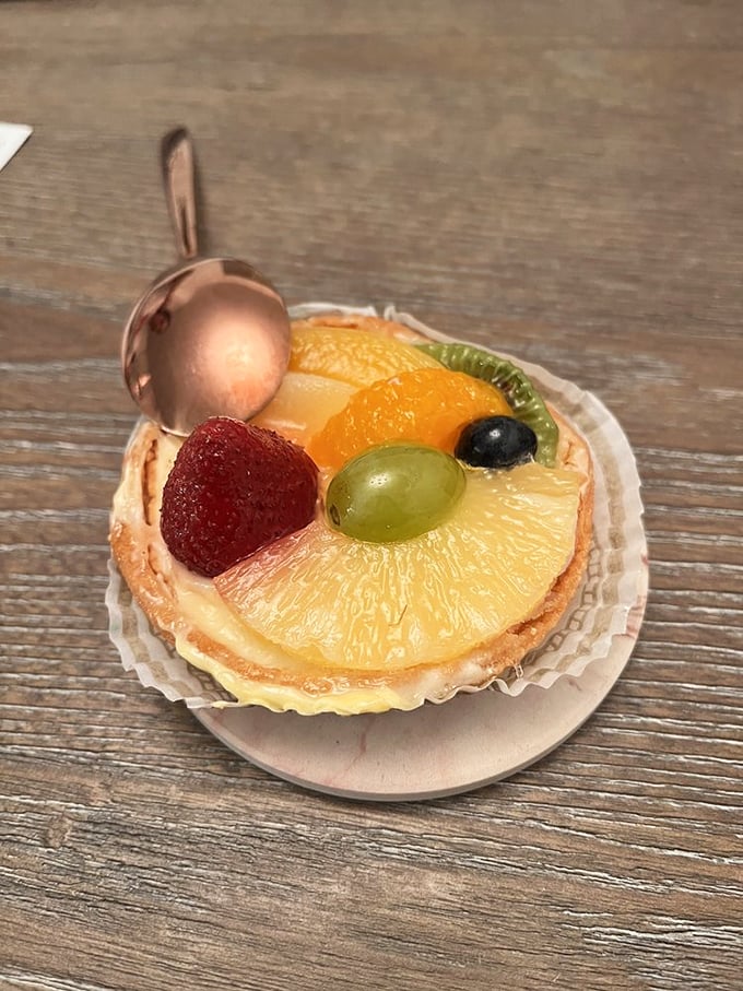 This fruit tart is summer's greatest hits album—starring pineapple, strawberry, and kiwi on a creamy stage with a buttery crust backdrop.