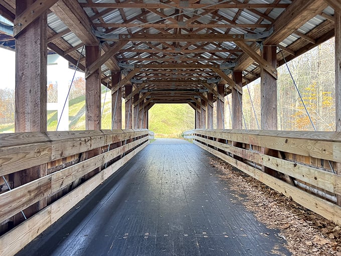Wooden bones and steel skin create a cathedral-like passage. Walking through is both architectural appreciation and spiritual experience.