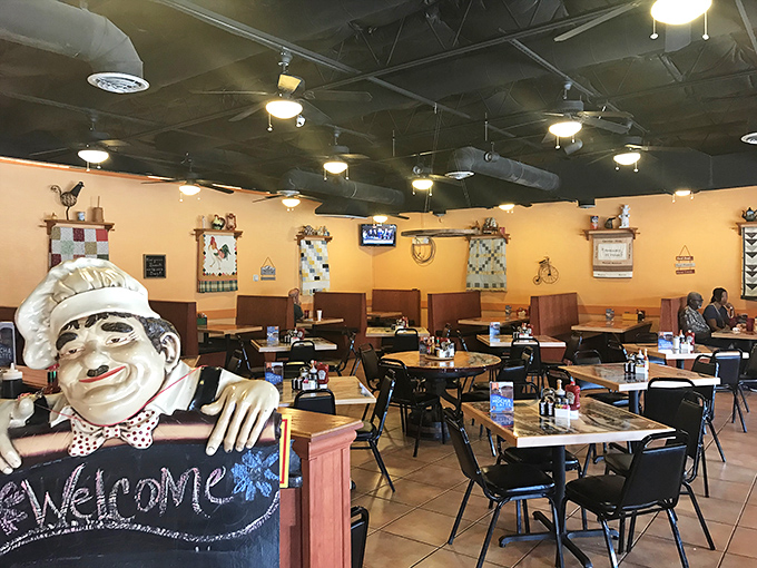The chef's statue welcomes you with a chalkboard greeting, like a sentinel guarding the gateway to breakfast paradise.