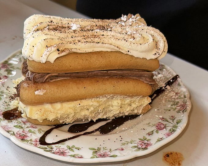 Tiramisu reimagined as a towering achievement—ladyfingers and mascarpone stacked with the confidence of a dessert that knows its worth.