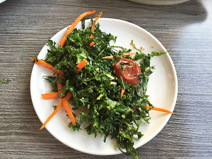 A kale salad that doesn't taste like punishment—bright carrots and tomato add pops of color and flavor to this actually-craveable green dish.